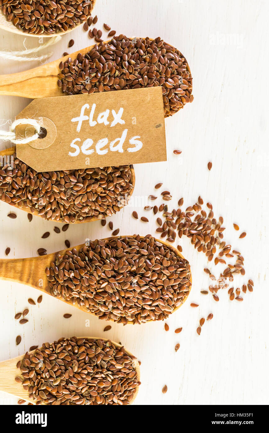 Flax seeds on painted wood board Stock Photo - Alamy