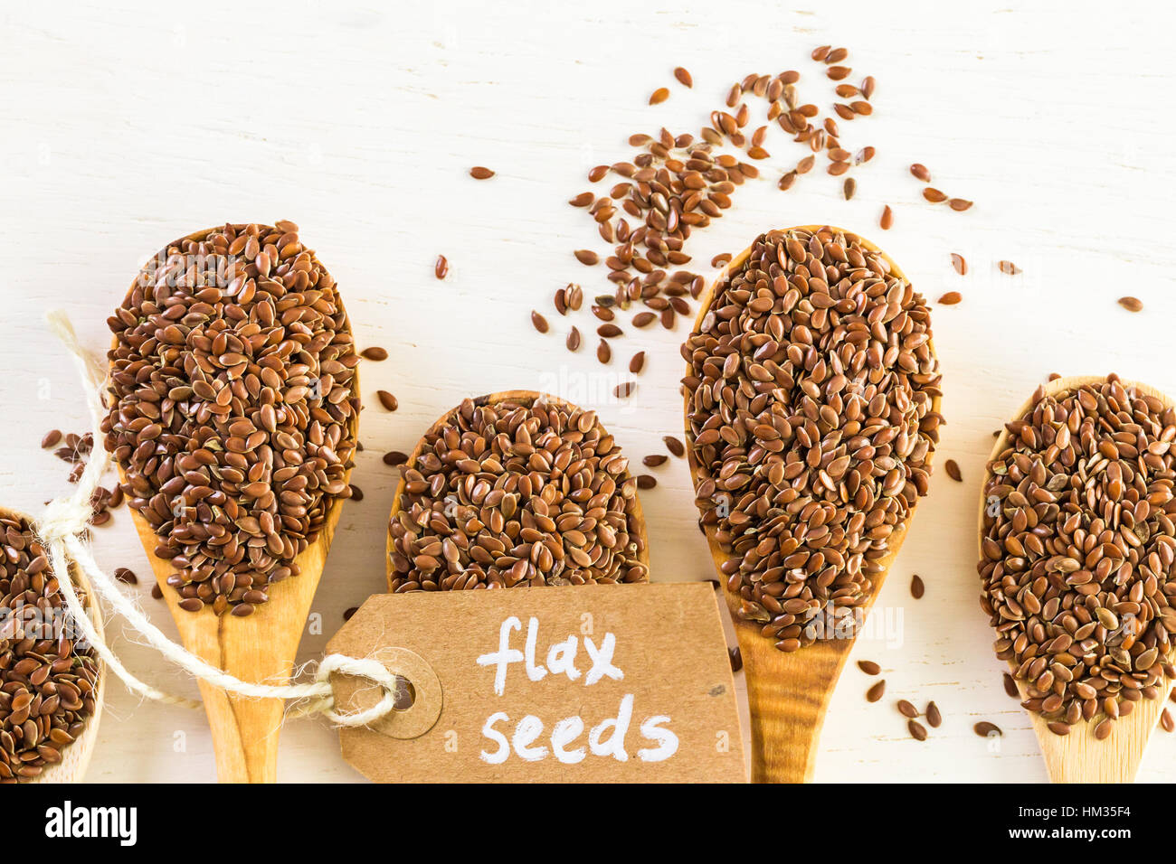 Flax seeds on painted wood board Stock Photo - Alamy