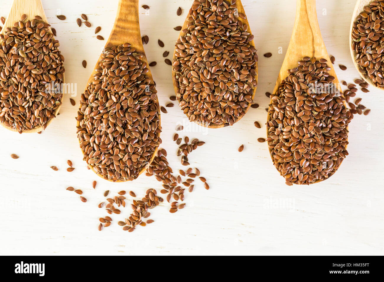 Flax seeds on painted wood board Stock Photo - Alamy