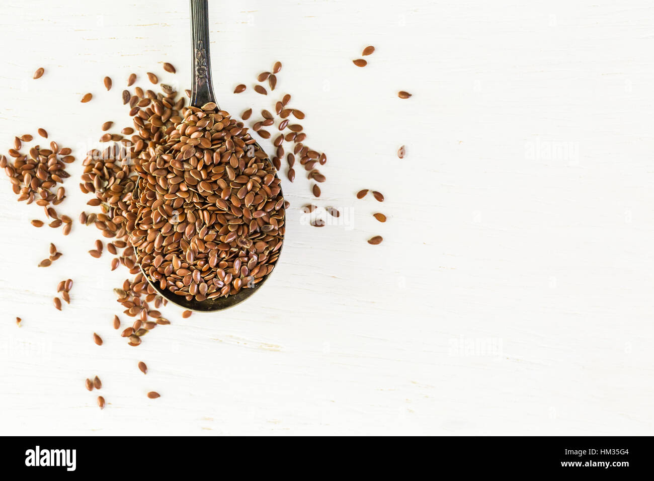 Flax seeds on painted wood board Stock Photo - Alamy