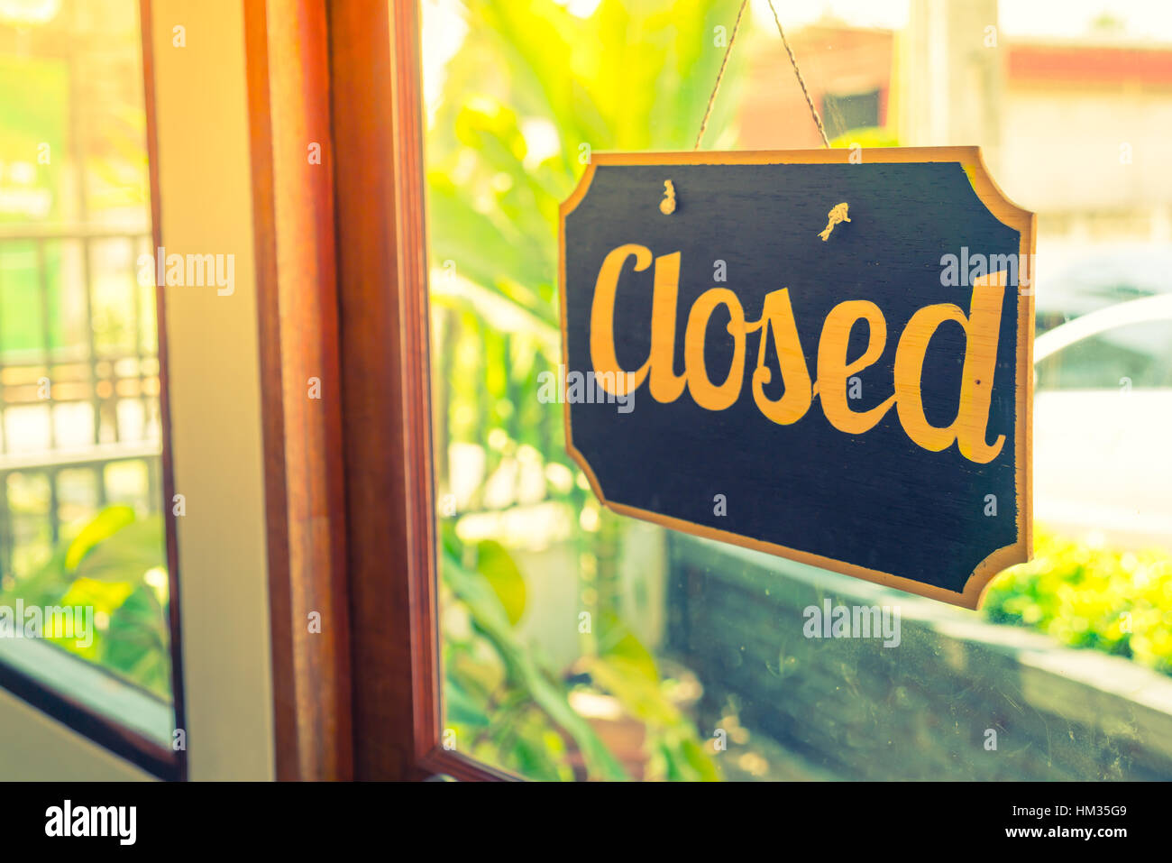 Closed sign on a glass door ( Filtered image processed vintage effect ...