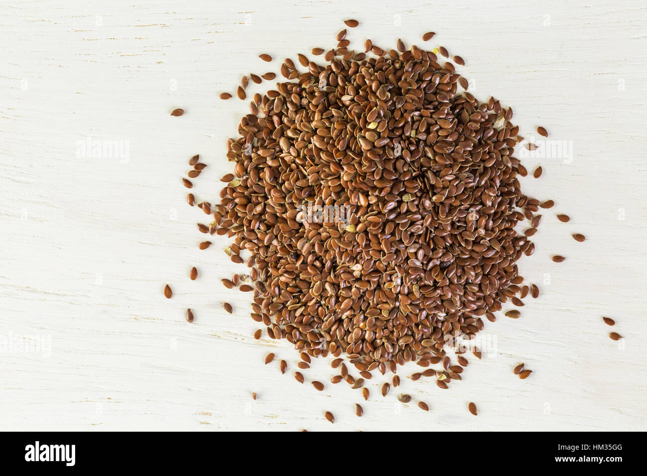 Flax seeds on painted wood board Stock Photo - Alamy
