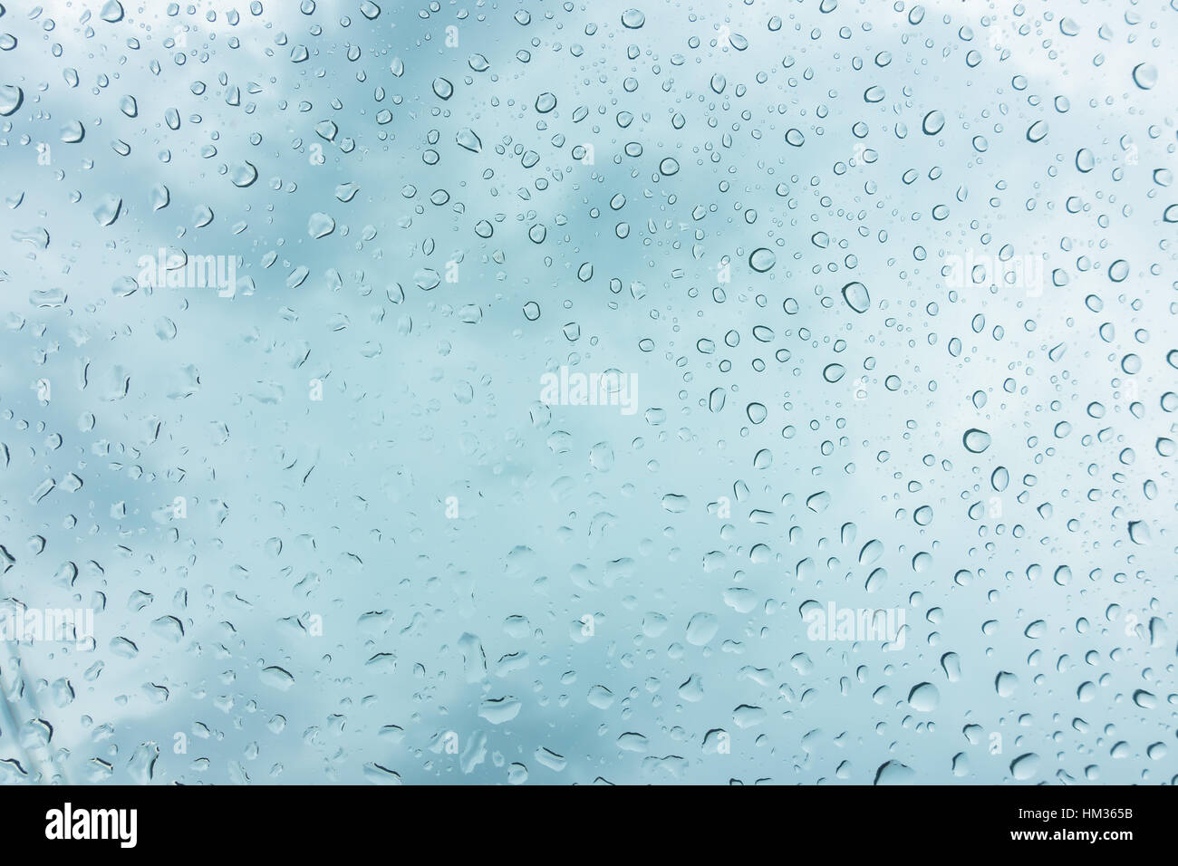 Drops of water on glass window over blue sky Stock Photo - Alamy