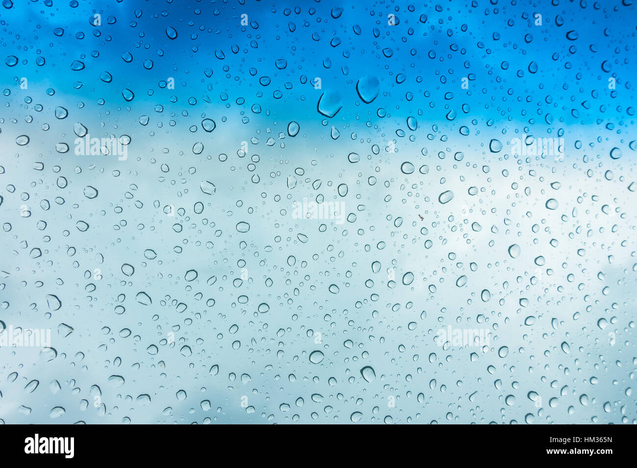 Drops of water on glass window over blue sky Stock Photo - Alamy