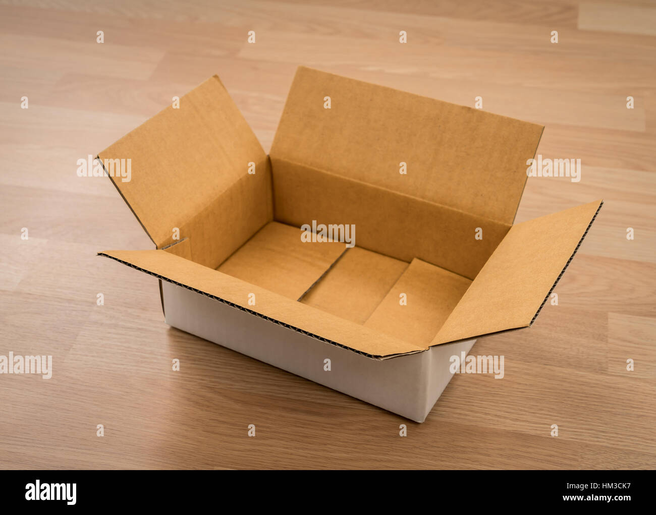 Cardboard box on wood Stock Photo - Alamy