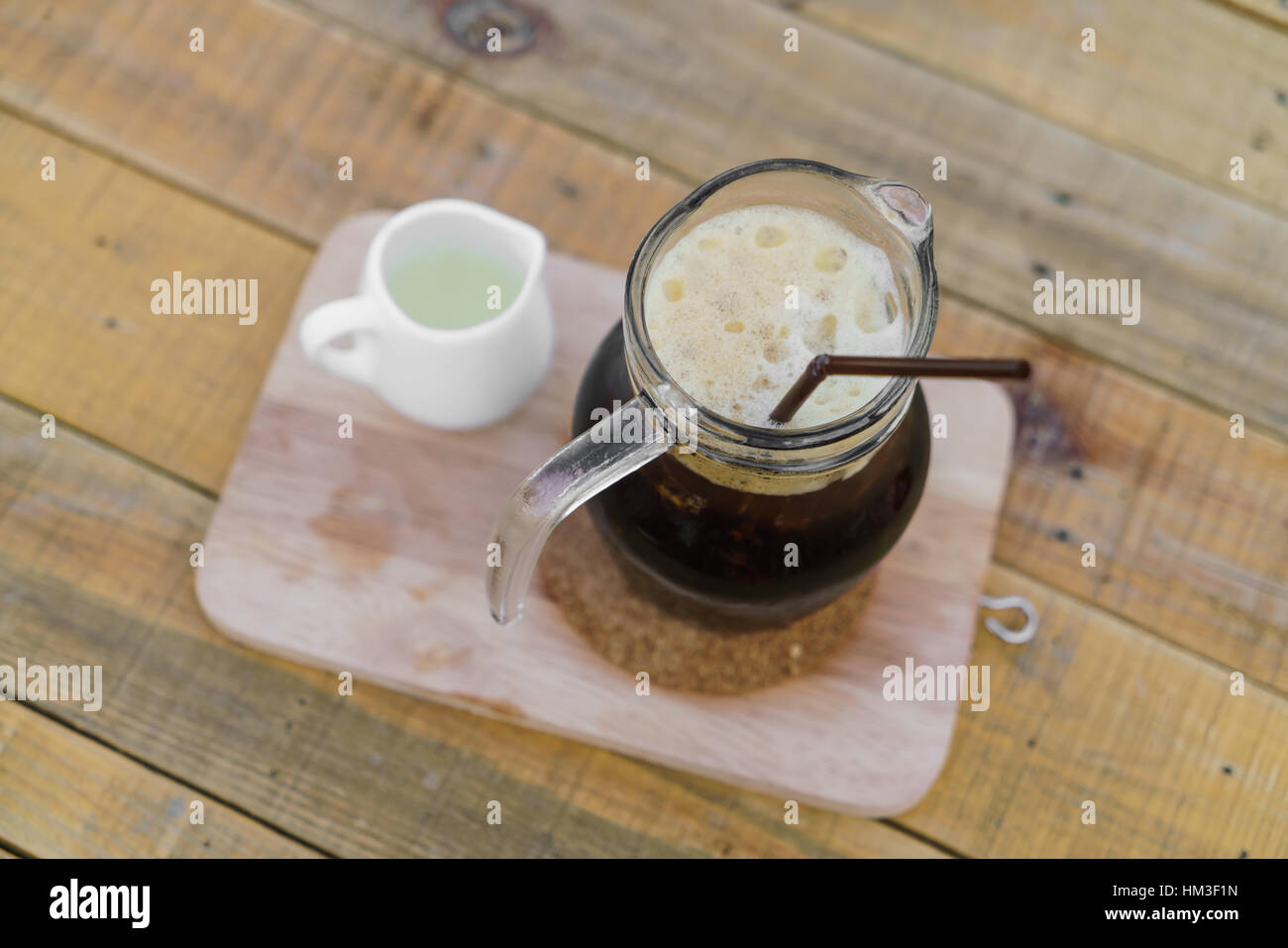 Ice cold coffee on a wooden table Stock Photo - Alamy