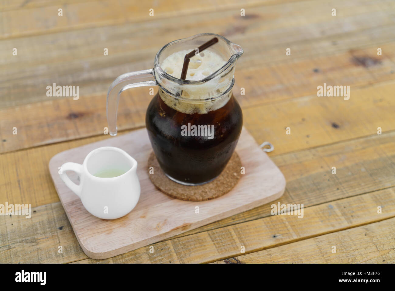 Ice cold coffee on a wooden table Stock Photo - Alamy
