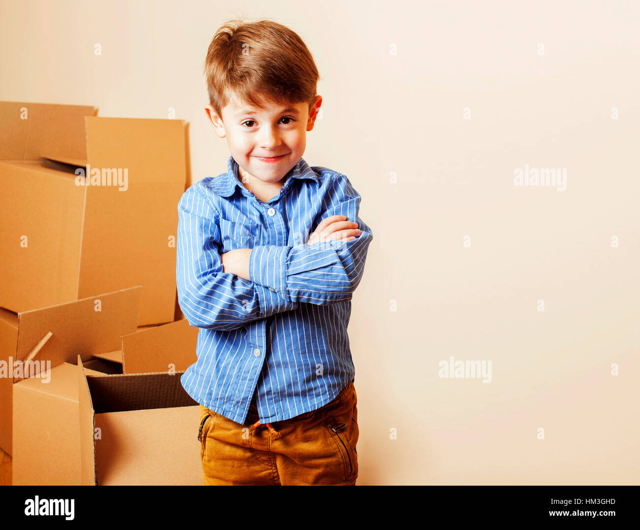 little cute boy in empty room, remoove to new house. home alone Stock ...