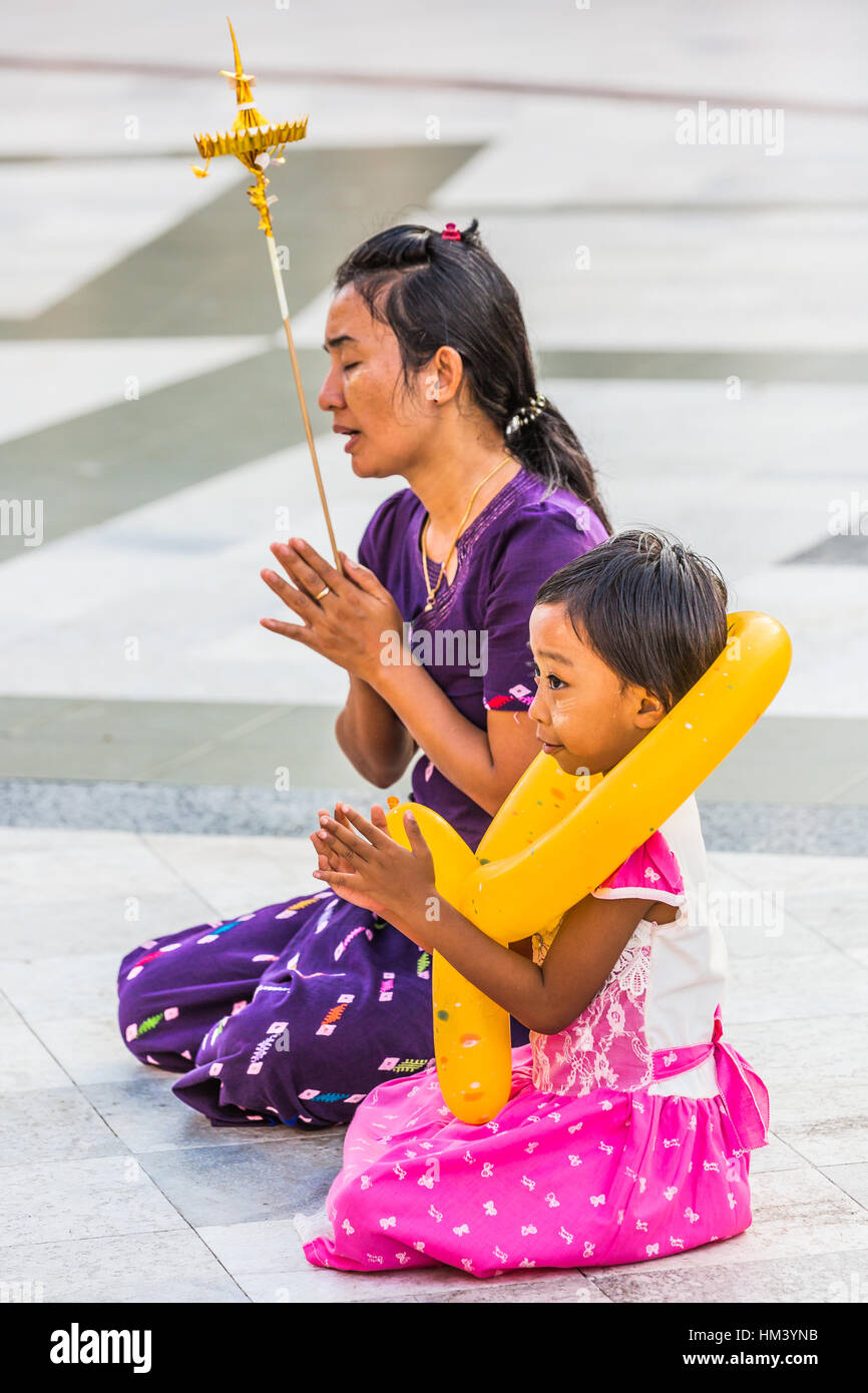 YANGON, MYANMAR - DECEMBER 16, 2016 : woman and her child praying at ...
