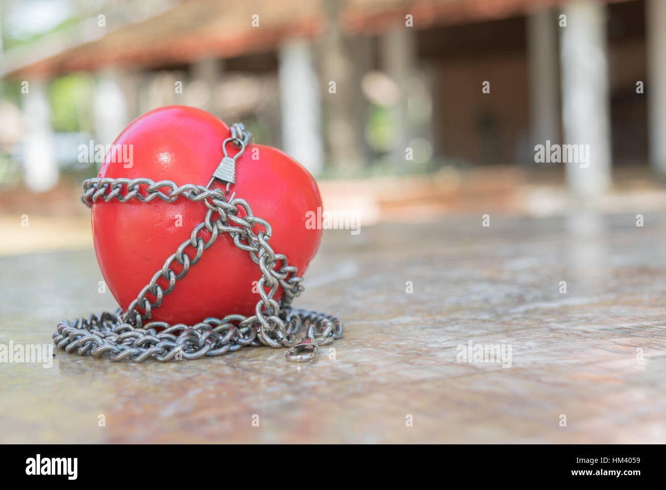 Red heart tied with chains, Valentine Concept Stock Photo - Alamy