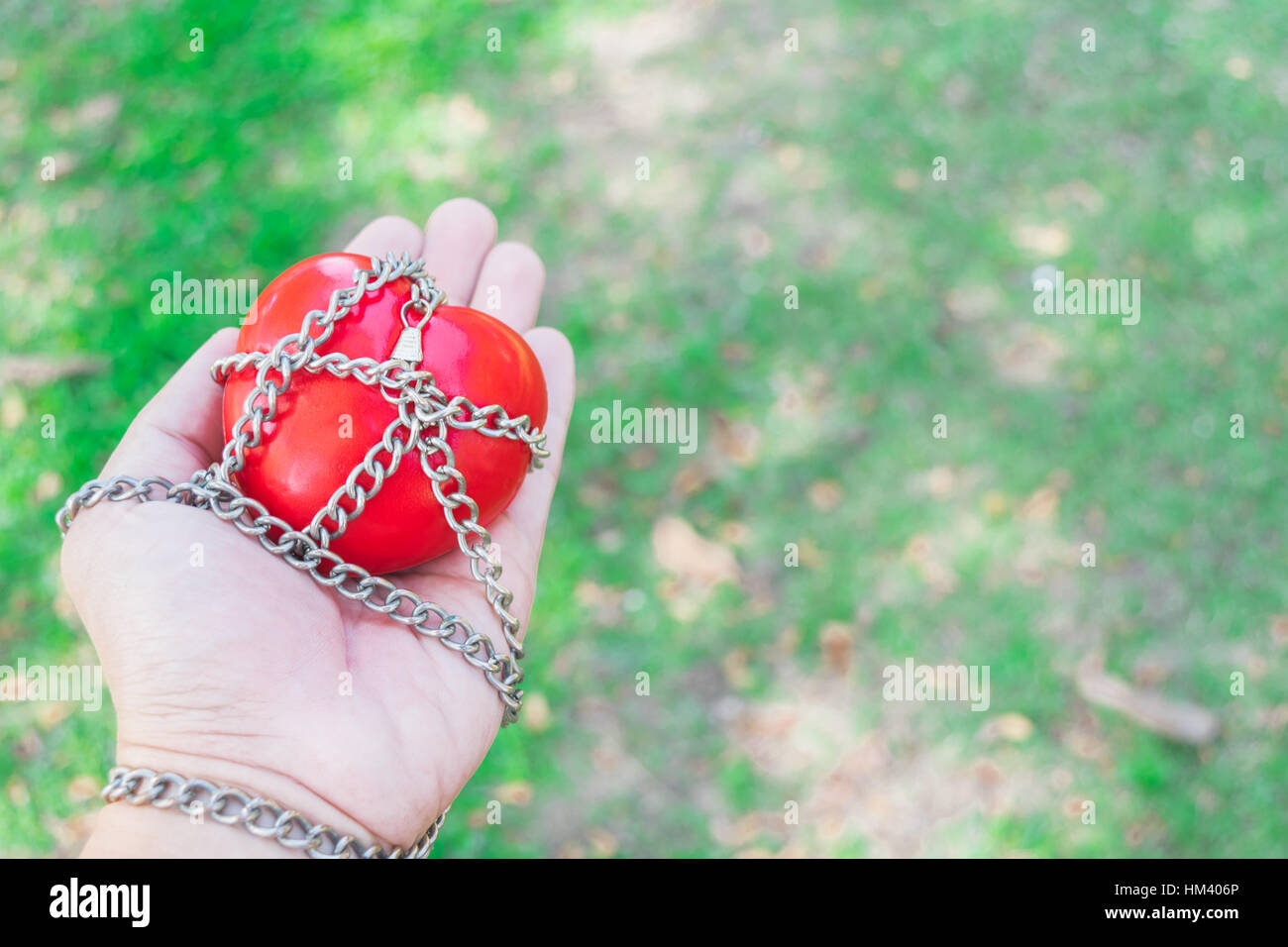 Red heart tied with chains, Valentine Concept Stock Photo - Alamy