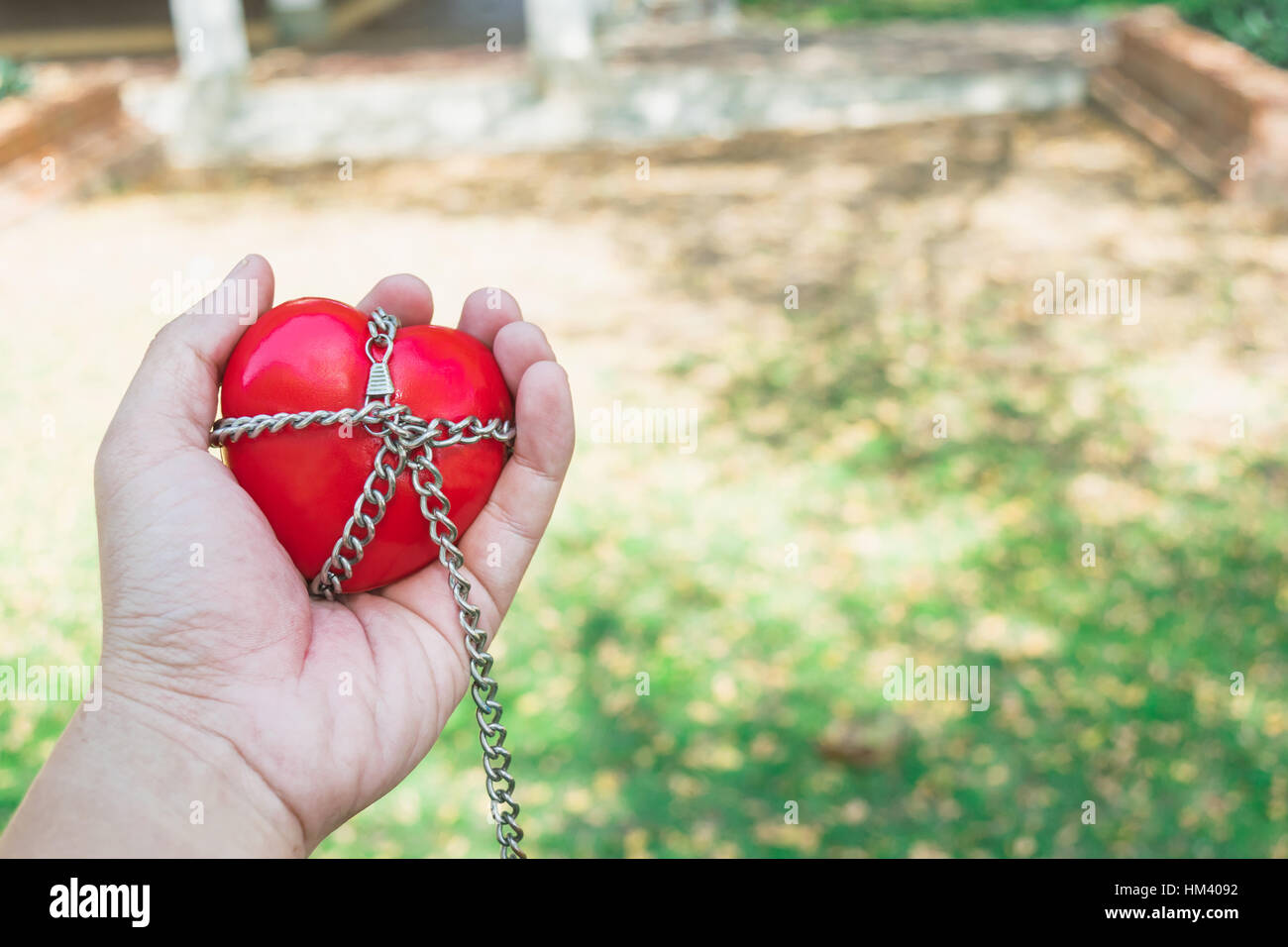 Red heart tied with chains, Valentine Concept Stock Photo - Alamy