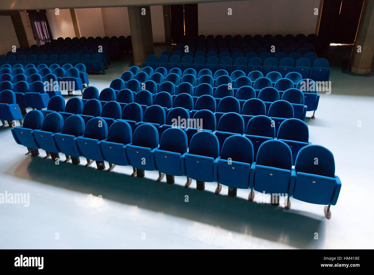 Rows of red color theatre chairs in conference room Stock Photo - Alamy