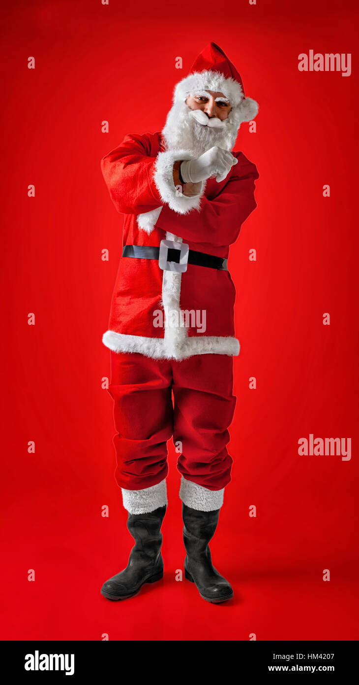 Santa Claus making umbrella Italian gesture on red background Stock ...
