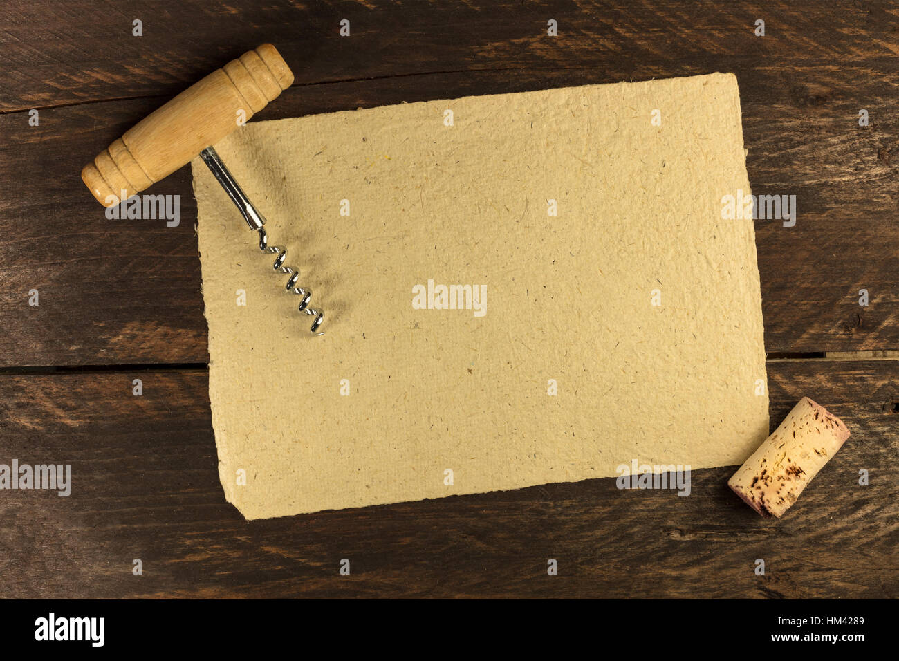 Photo of an old-fashioned corkscrew with a cork, shot from above on a ...