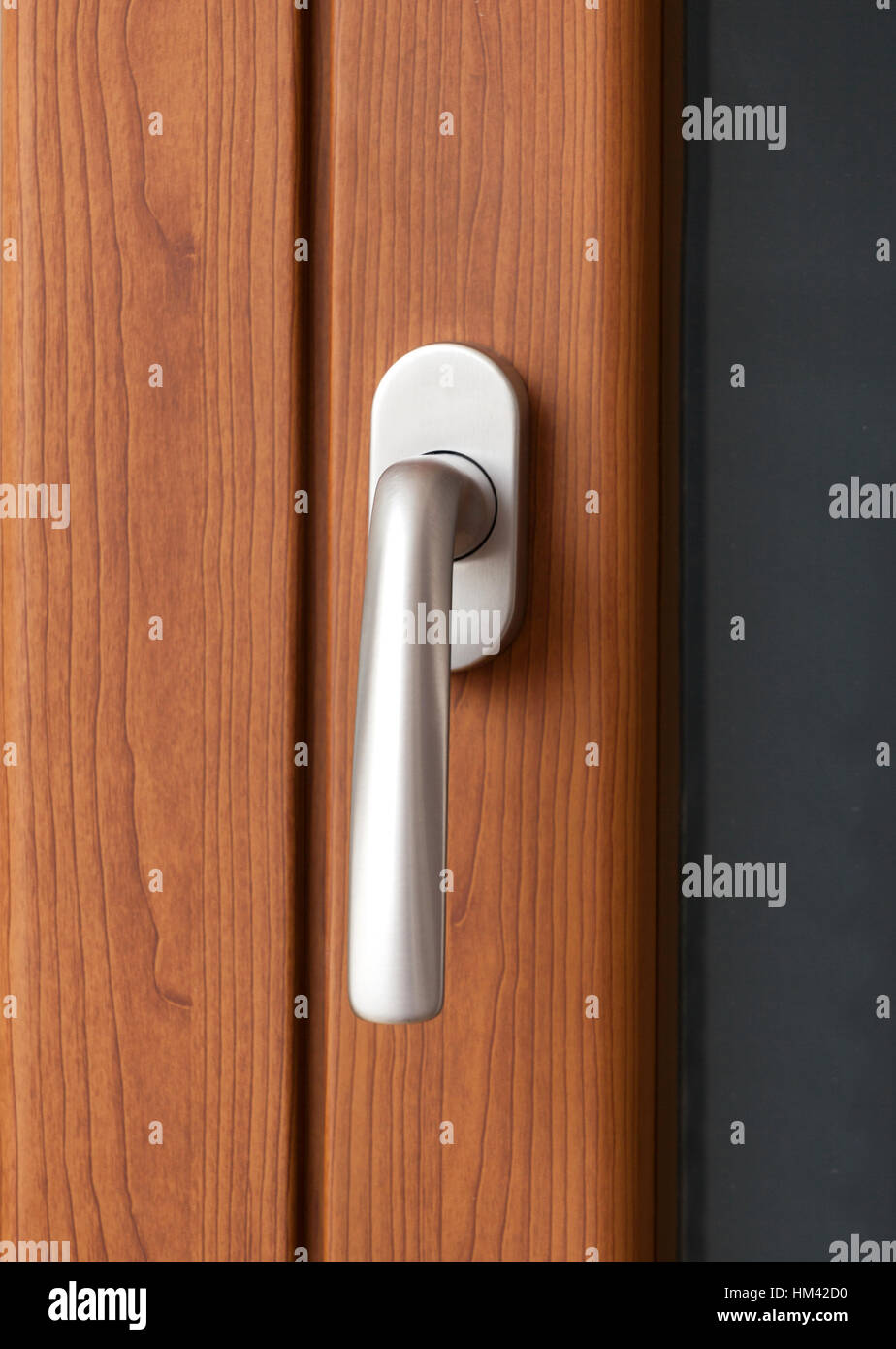 Window handle silver satin with faux wood frame Stock Photo - Alamy