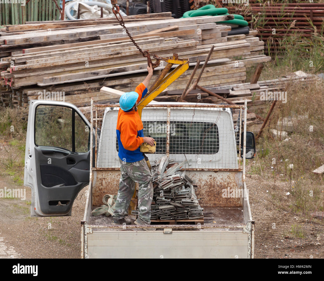 Workers at the construction site with the crane moving steel Stock ...