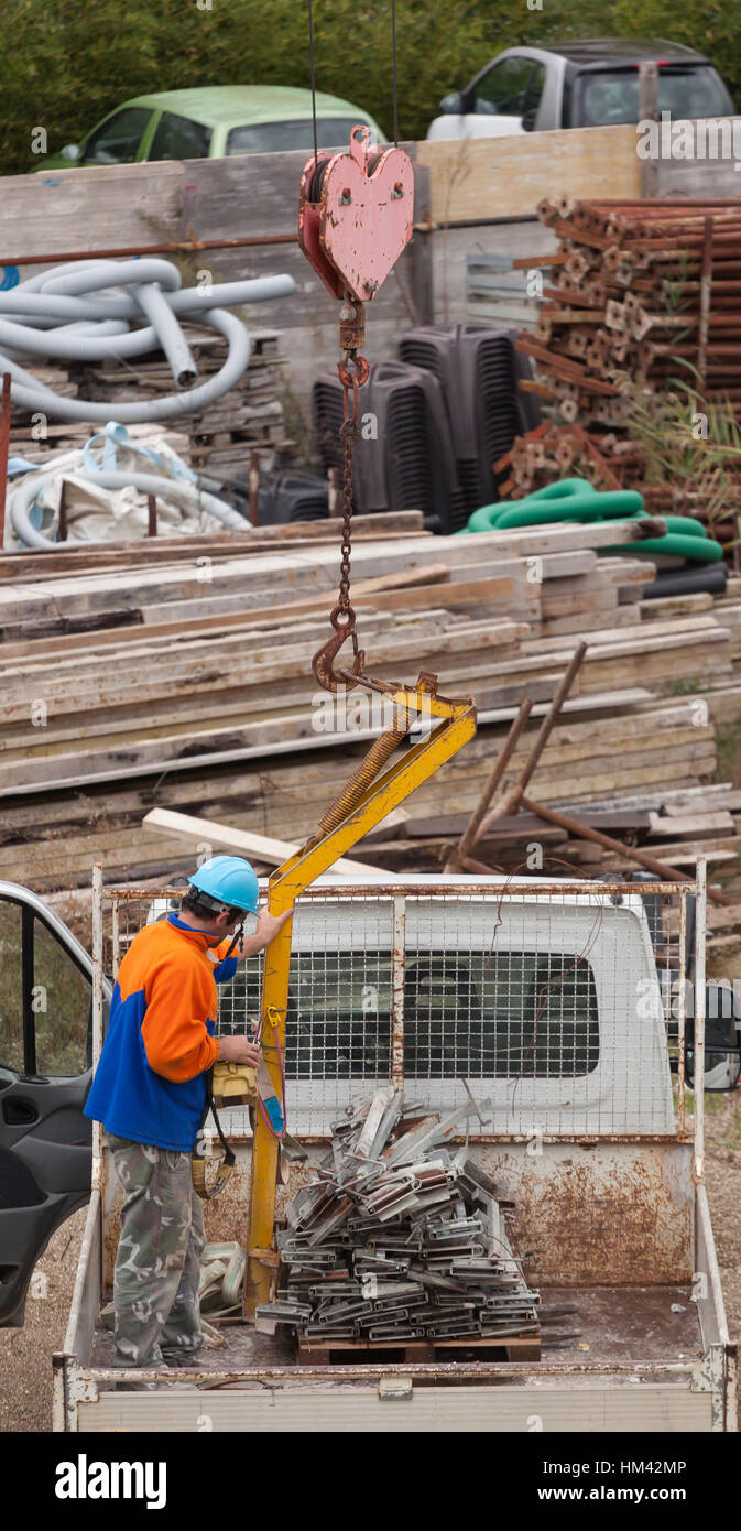 Workers at the construction site with the crane moving steel Stock ...