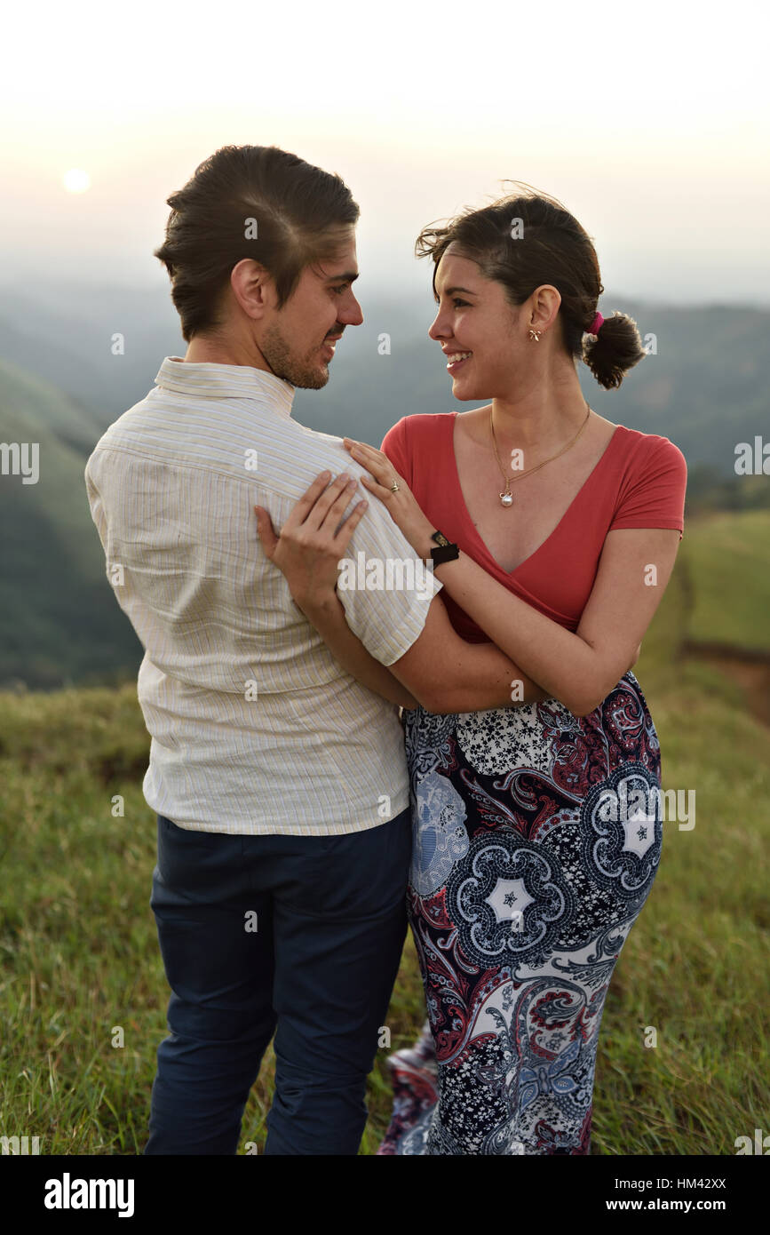 Man and girl look on each other outside in sunset Stock Photo - Alamy