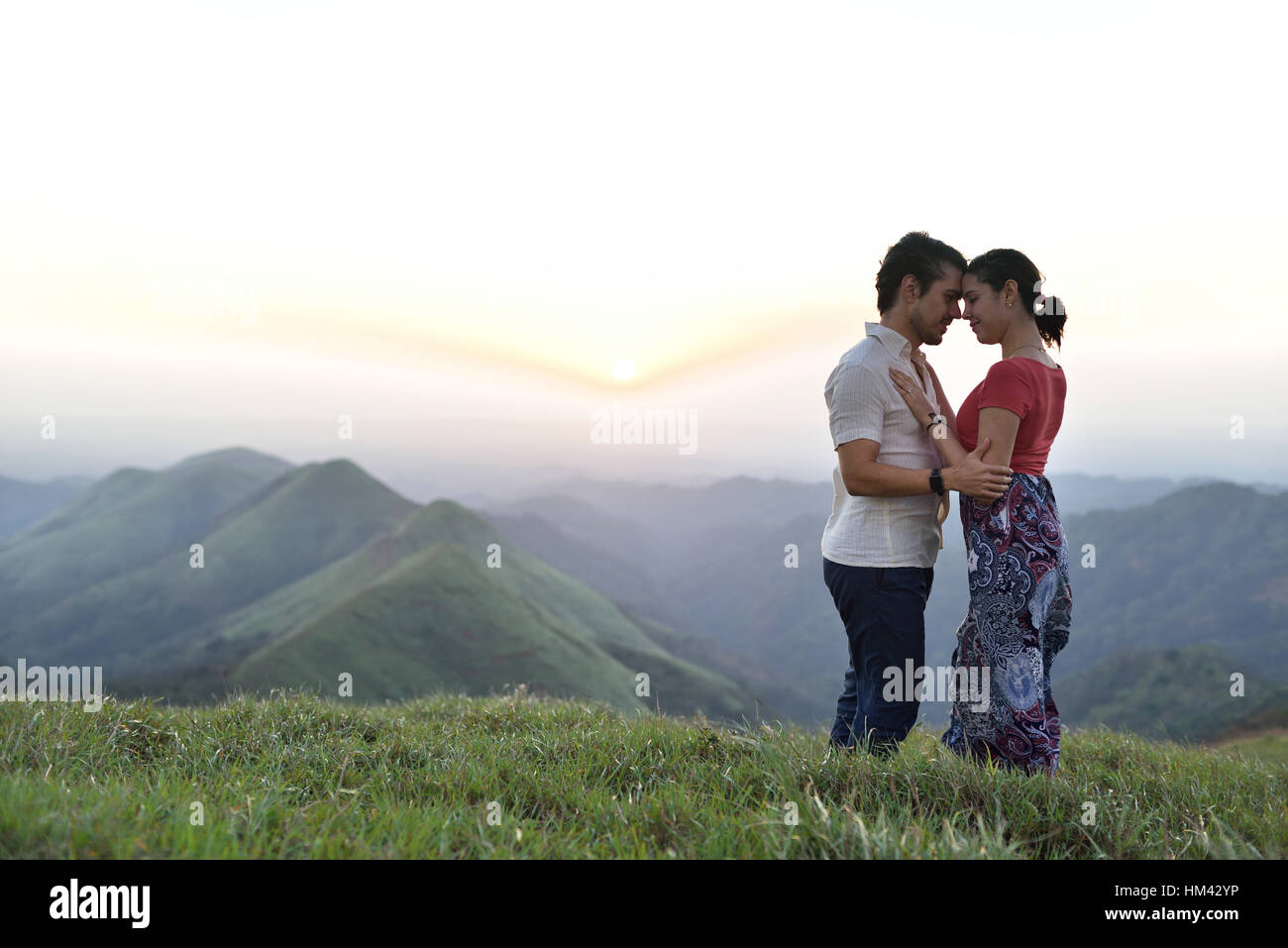 Romantic young couple kissing stand hi-res stock photography and images ...