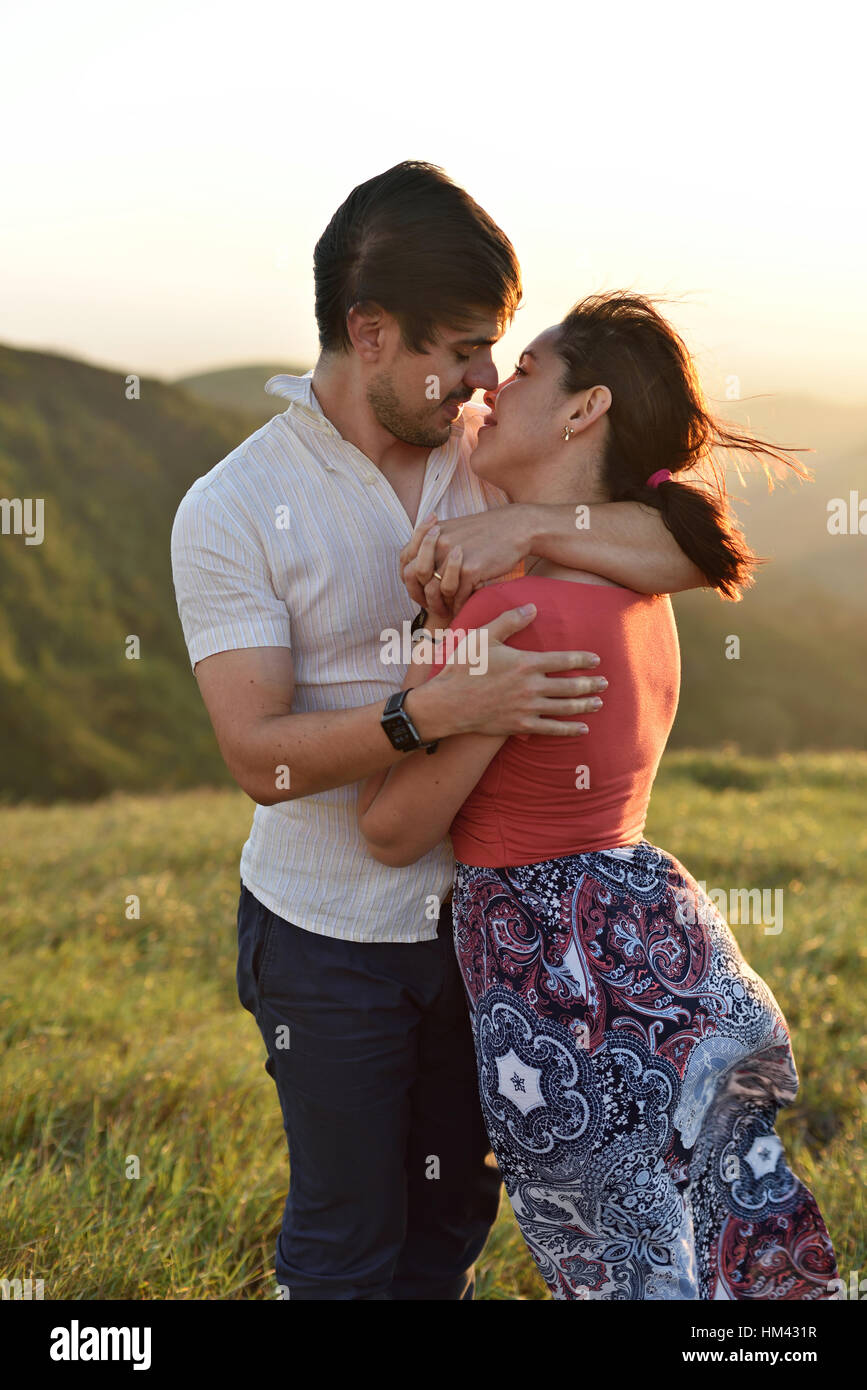 hugging lovely couple outside in summer sunset light Stock Photo - Alamy