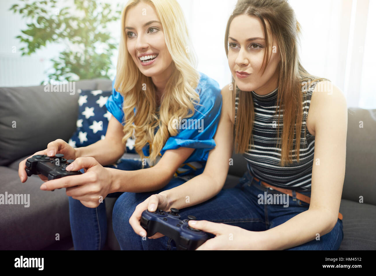 Girls playing a video game Stock Photo - Alamy