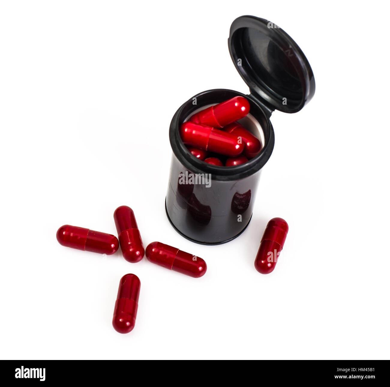 Red capsule medical jar in black on a white background Stock Photo - Alamy