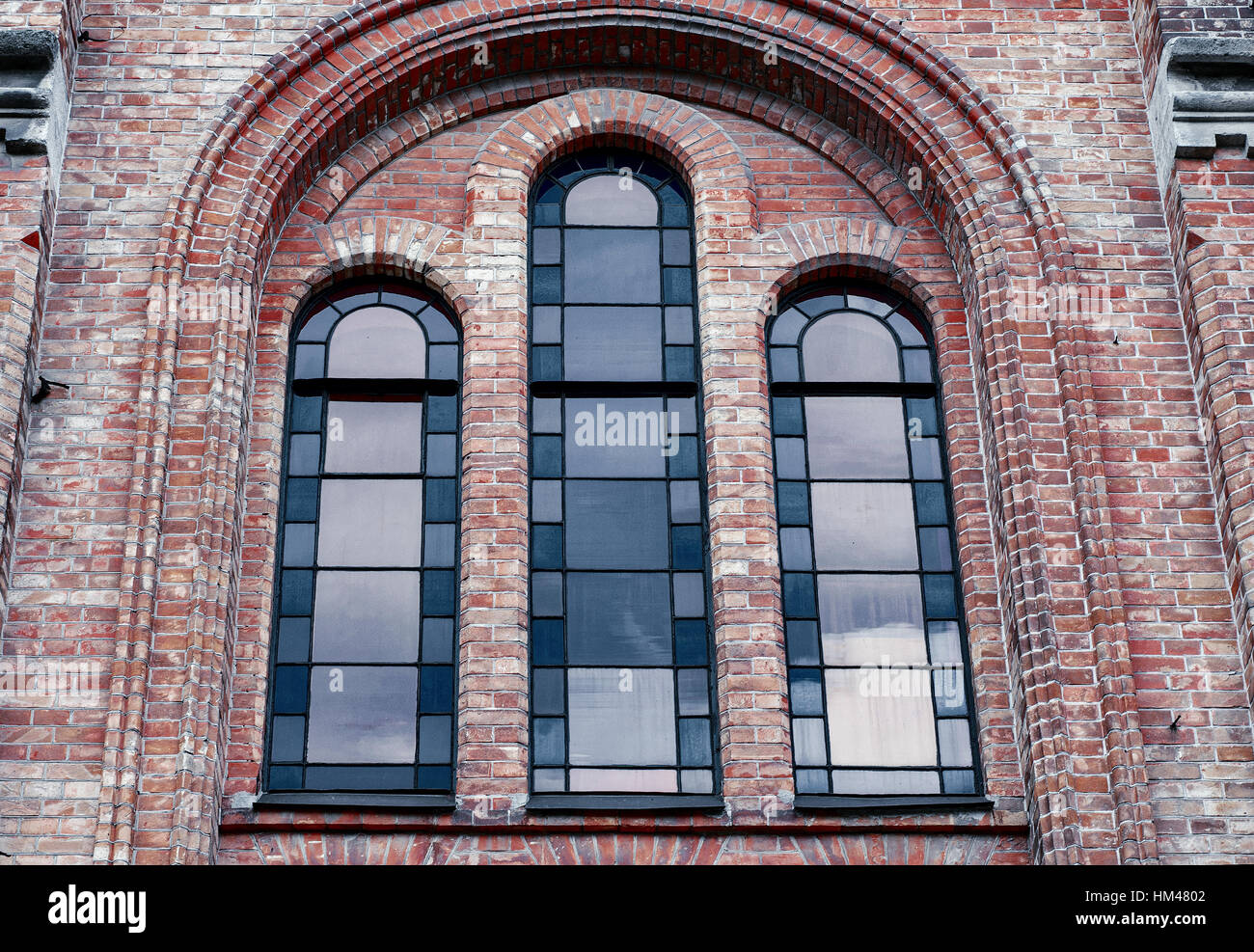 Window with stained glass windows in a brick building, view from below ...
