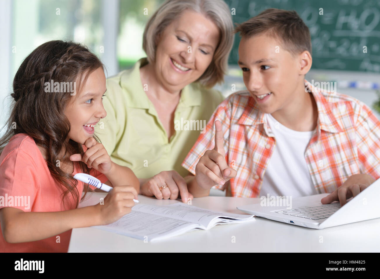 granny with grandchildren doing homework Stock Photo - Alamy