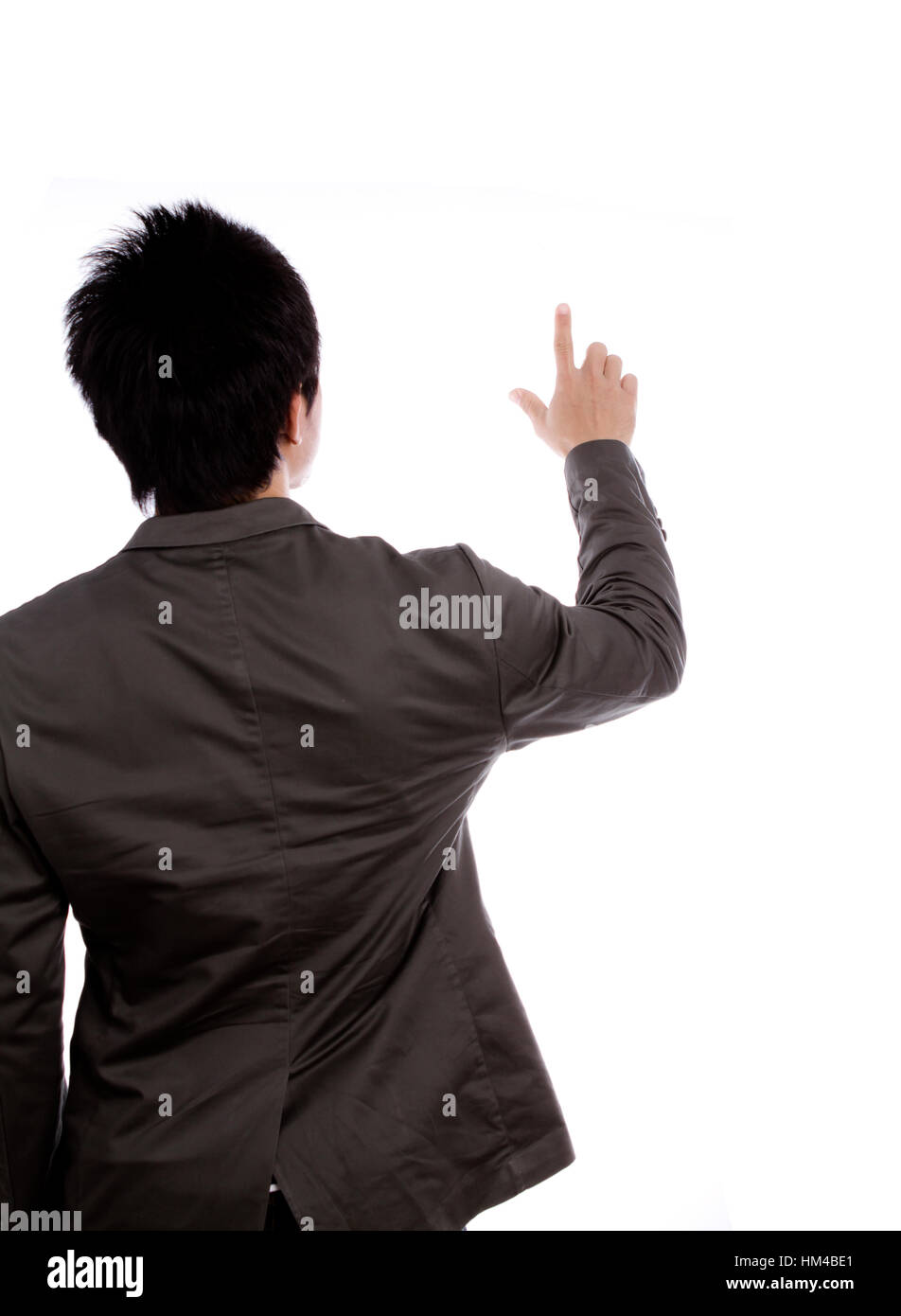 Back view of a young business man pointing at something over white ...