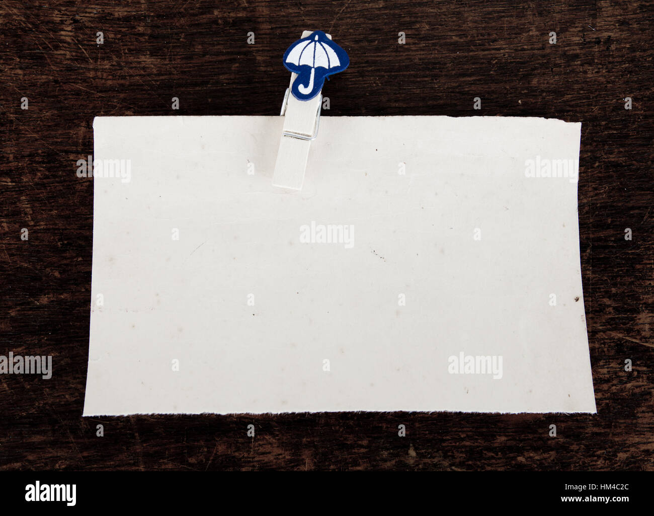 close up of an old paper and clothes peg on a wooden background Stock ...