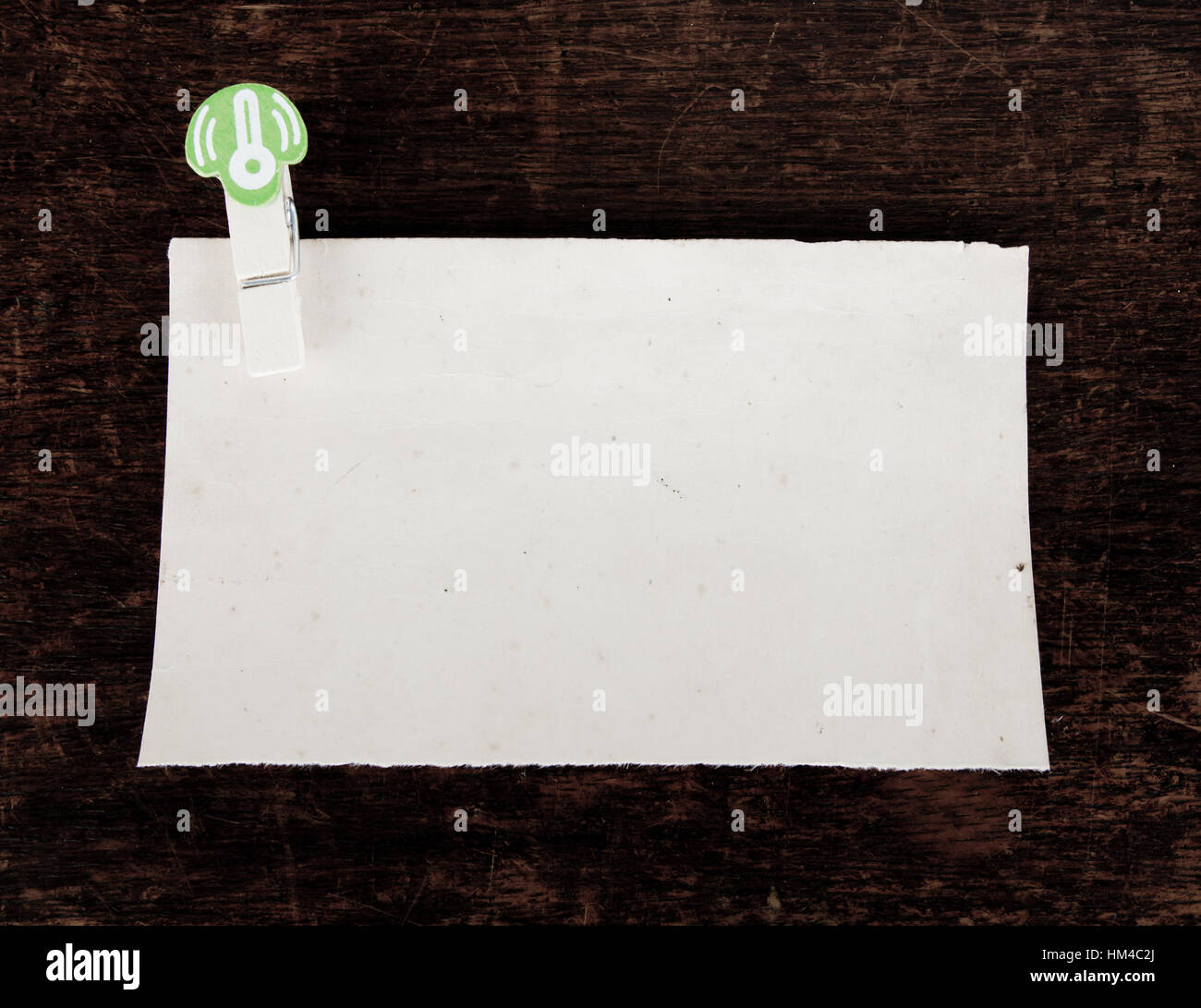 close up of an old paper and clothes peg on a wooden background Stock ...