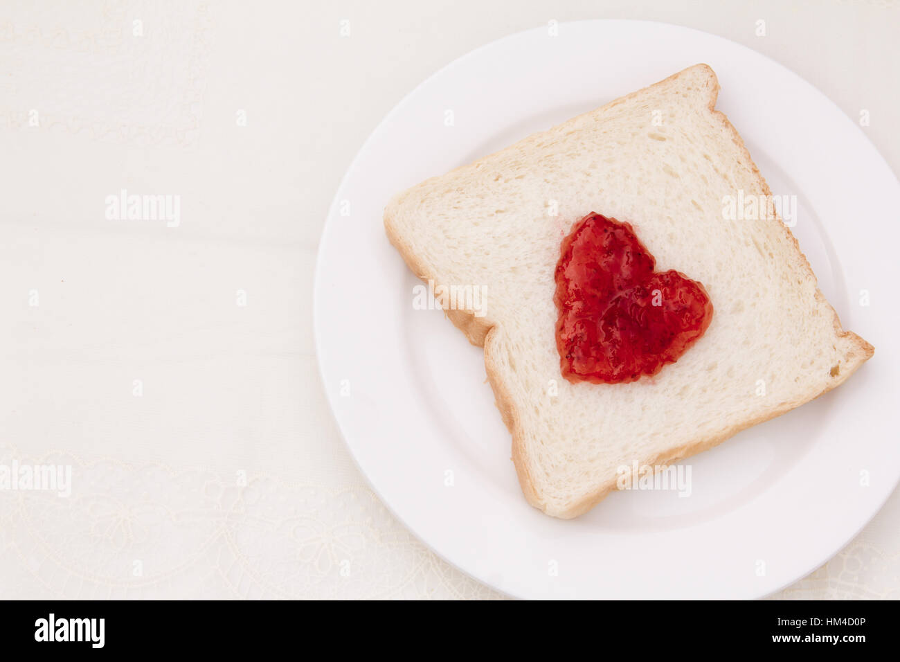 Toast with heart shape raspberry jam Stock Photo - Alamy