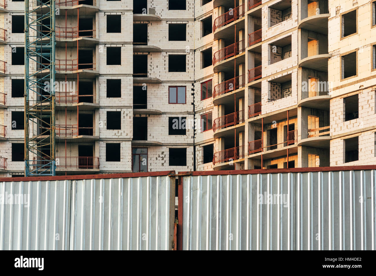 Construction of multistory building behind the closed gates Stock Photo ...