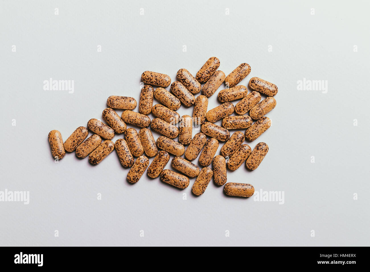 Pile vitamin tablets on a white table top view Stock Photo - Alamy