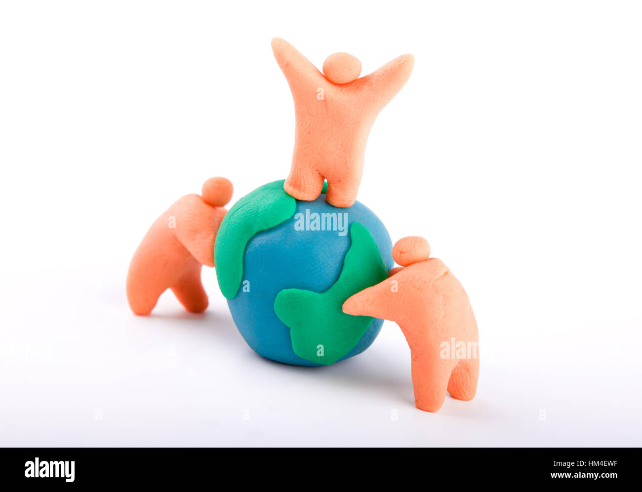 Plasticine of people embracing the earth Stock Photo - Alamy