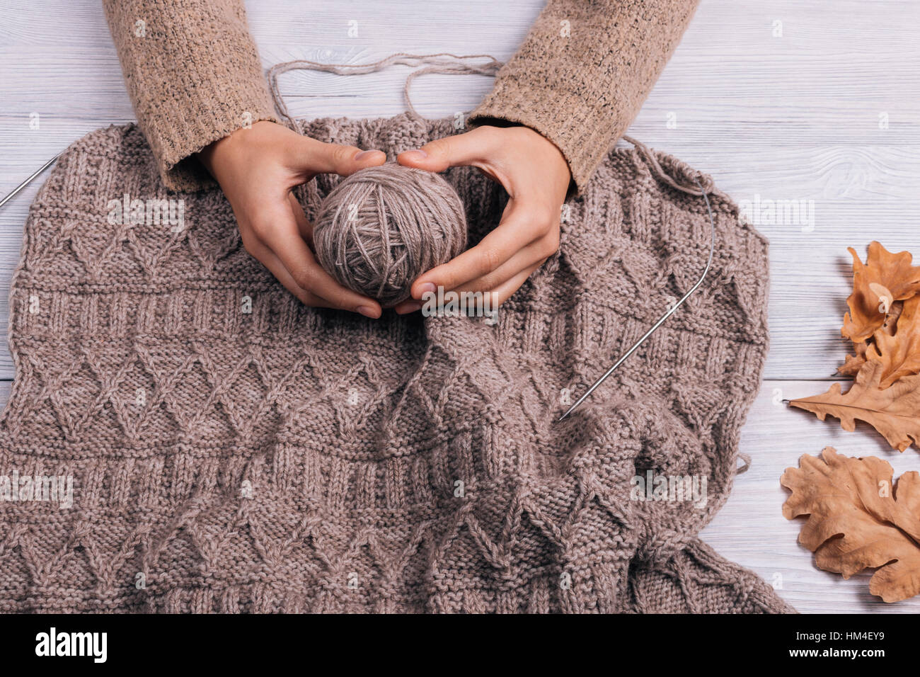 Top view of a woman's hands holding a ball of wool yarn in the ...