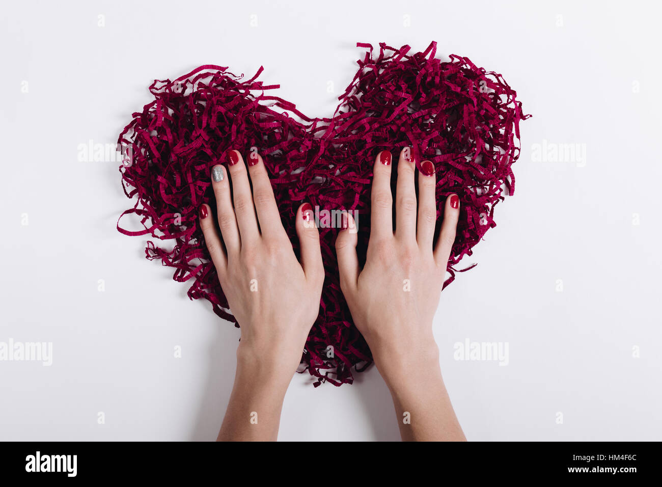 Red decorative heart and woman's hands with a manicure, top view Stock ...