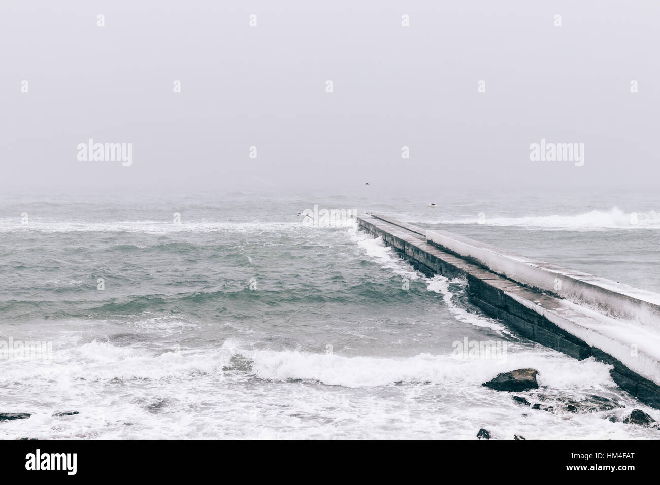 Views of the snow-covered pier, winter seascape Stock Photo - Alamy
