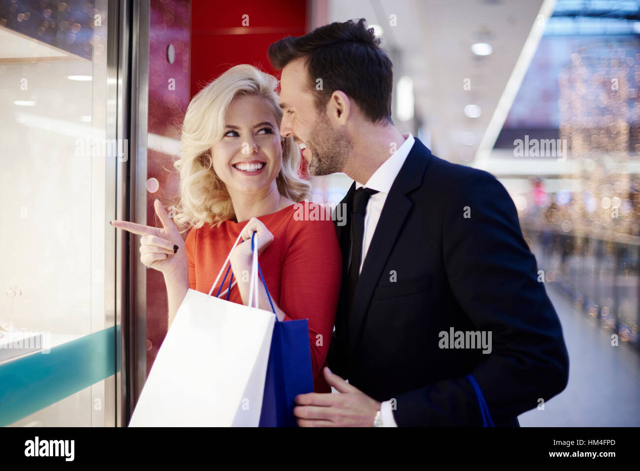 Two adults gazing at window shop Stock Photo - Alamy