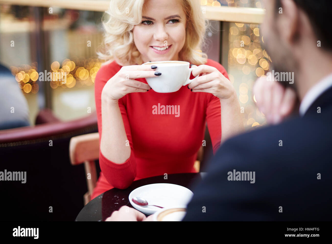 Woman sitting face to face with partner in the cafe Stock Photo - Alamy