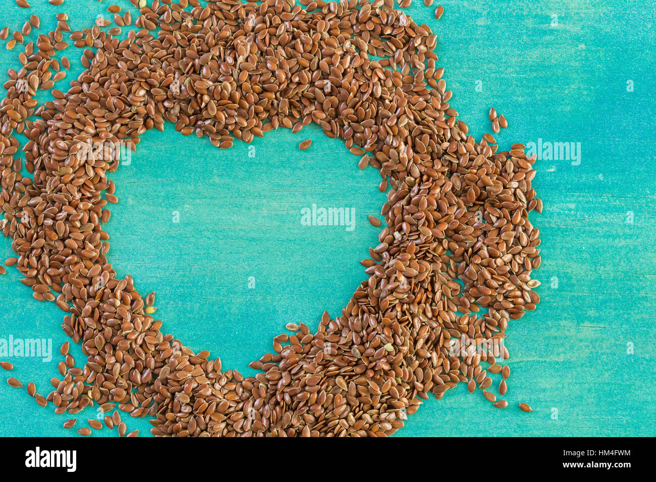 Flax seeds on painted wood board Stock Photo - Alamy