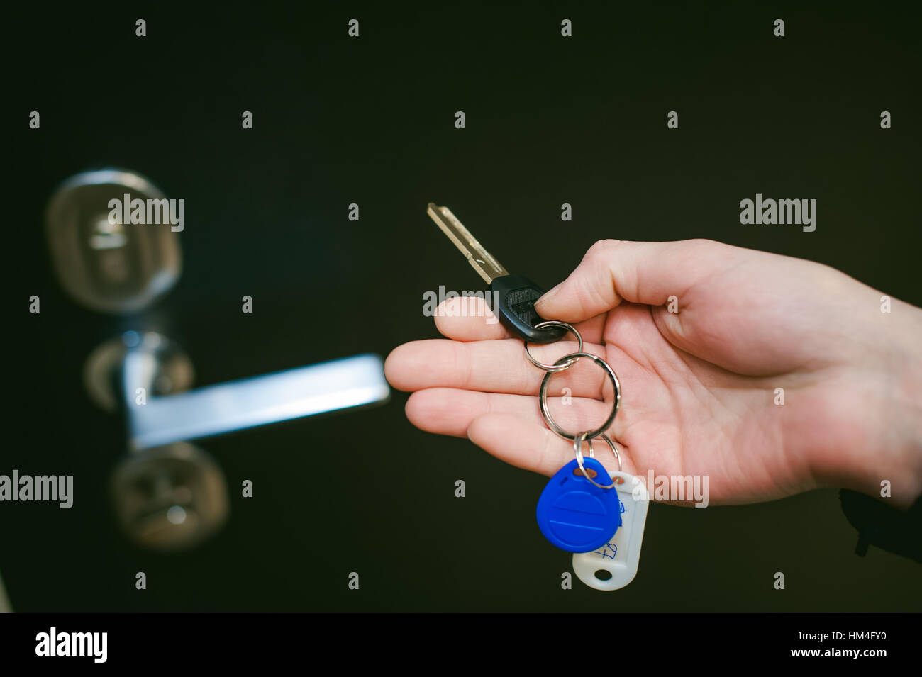 key to the door lock in the man's hand opening Stock Photo - Alamy