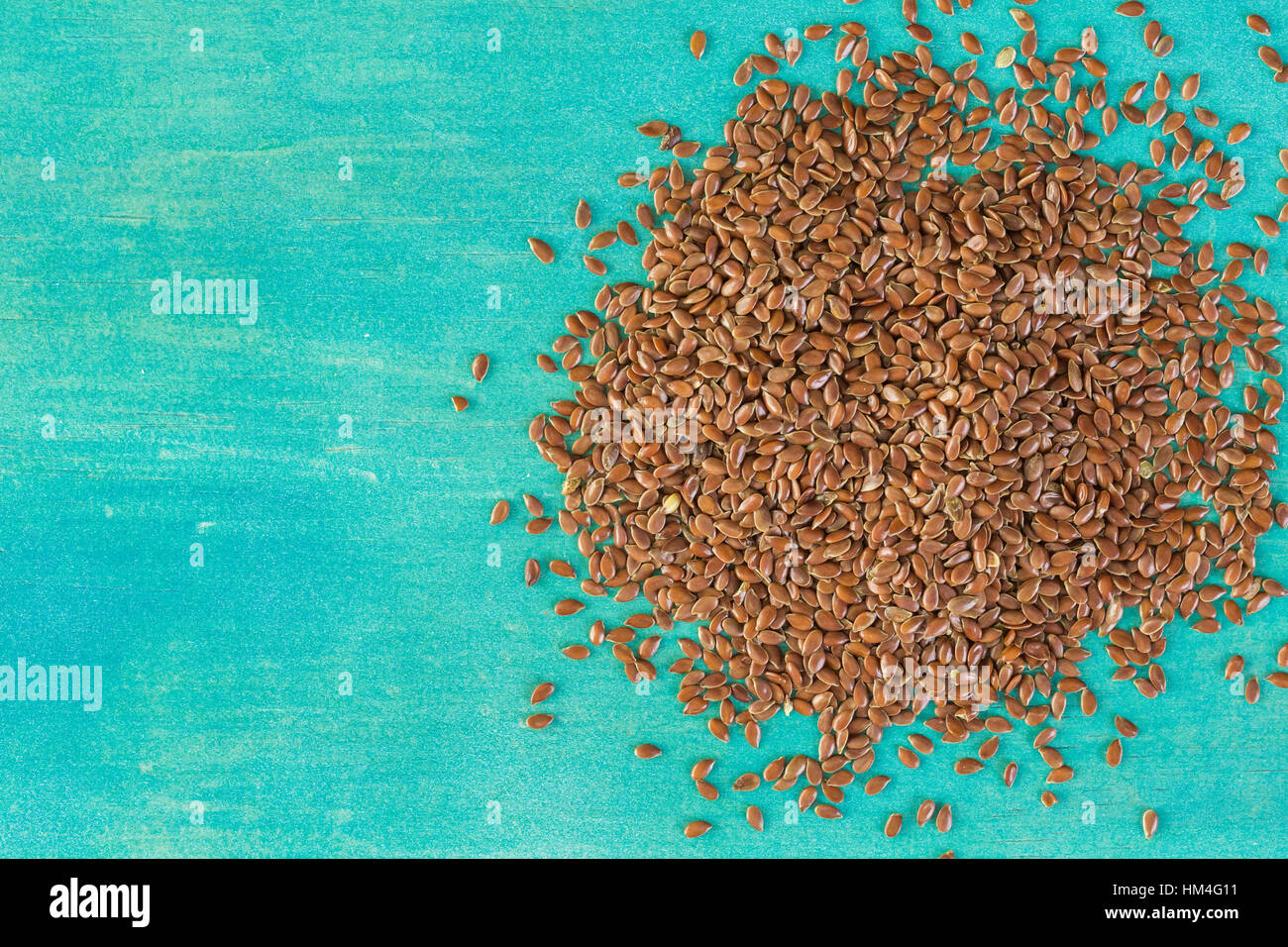 Flax seeds on painted wood board Stock Photo - Alamy
