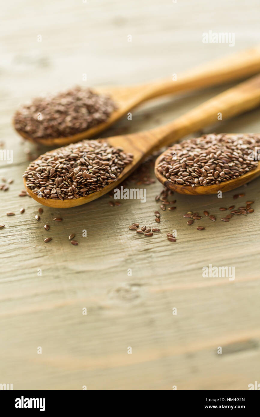 Flax seeds on painted wood board Stock Photo - Alamy