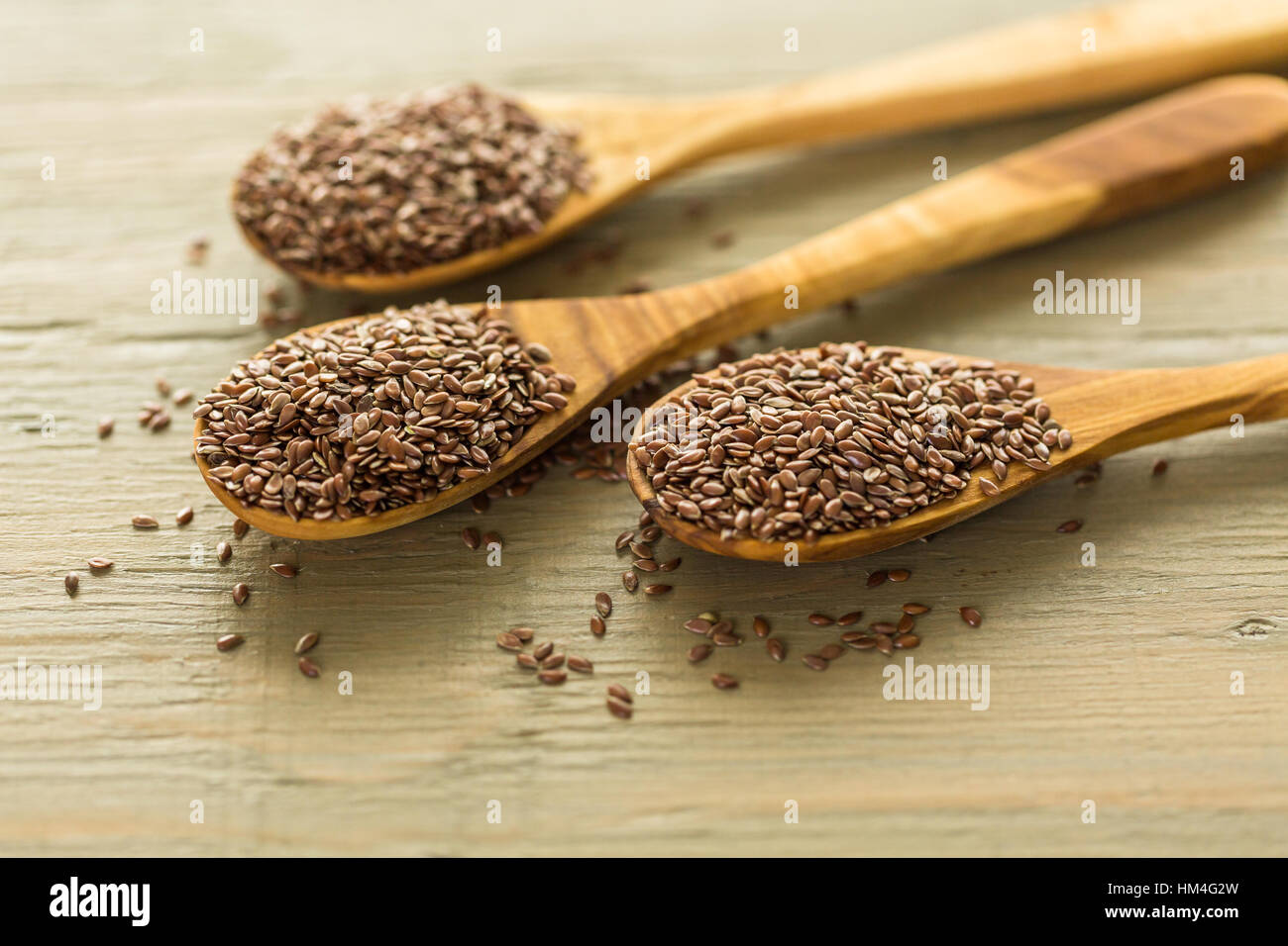 Flax seeds on painted wood board Stock Photo - Alamy