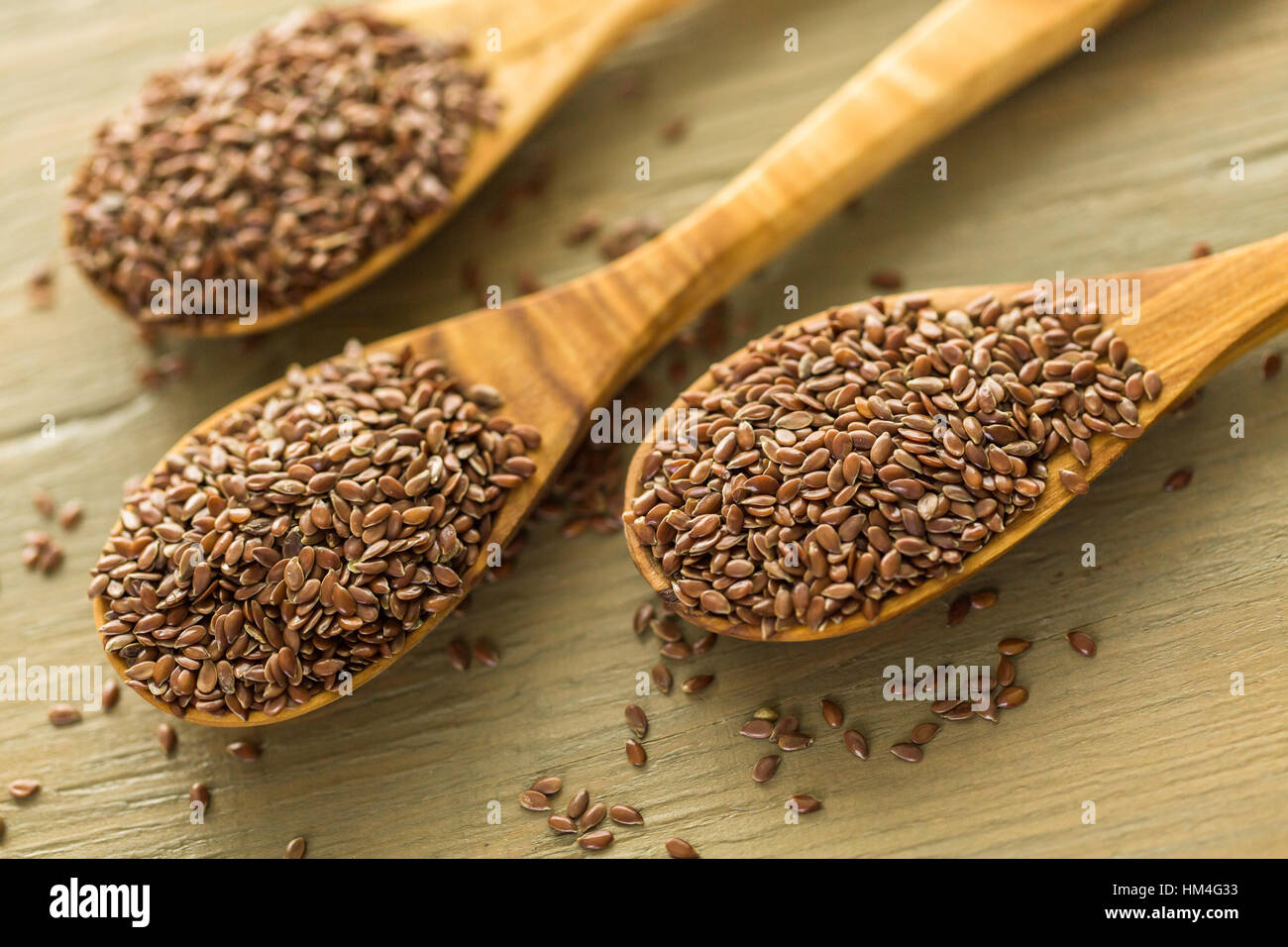 Flax seeds on painted wood board Stock Photo - Alamy