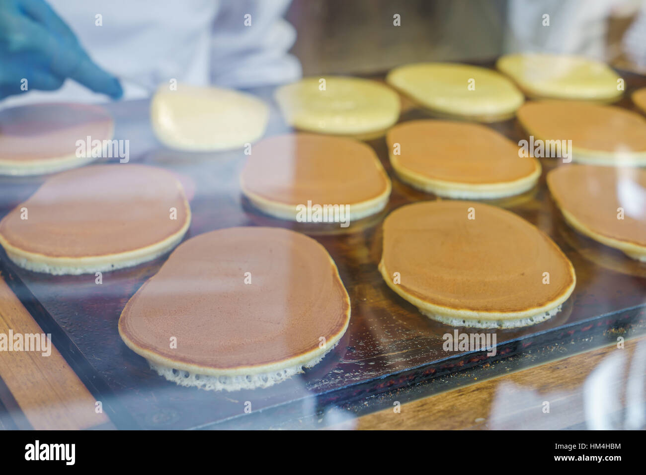Pancakes cooking ion griddle Stock Photo - Alamy