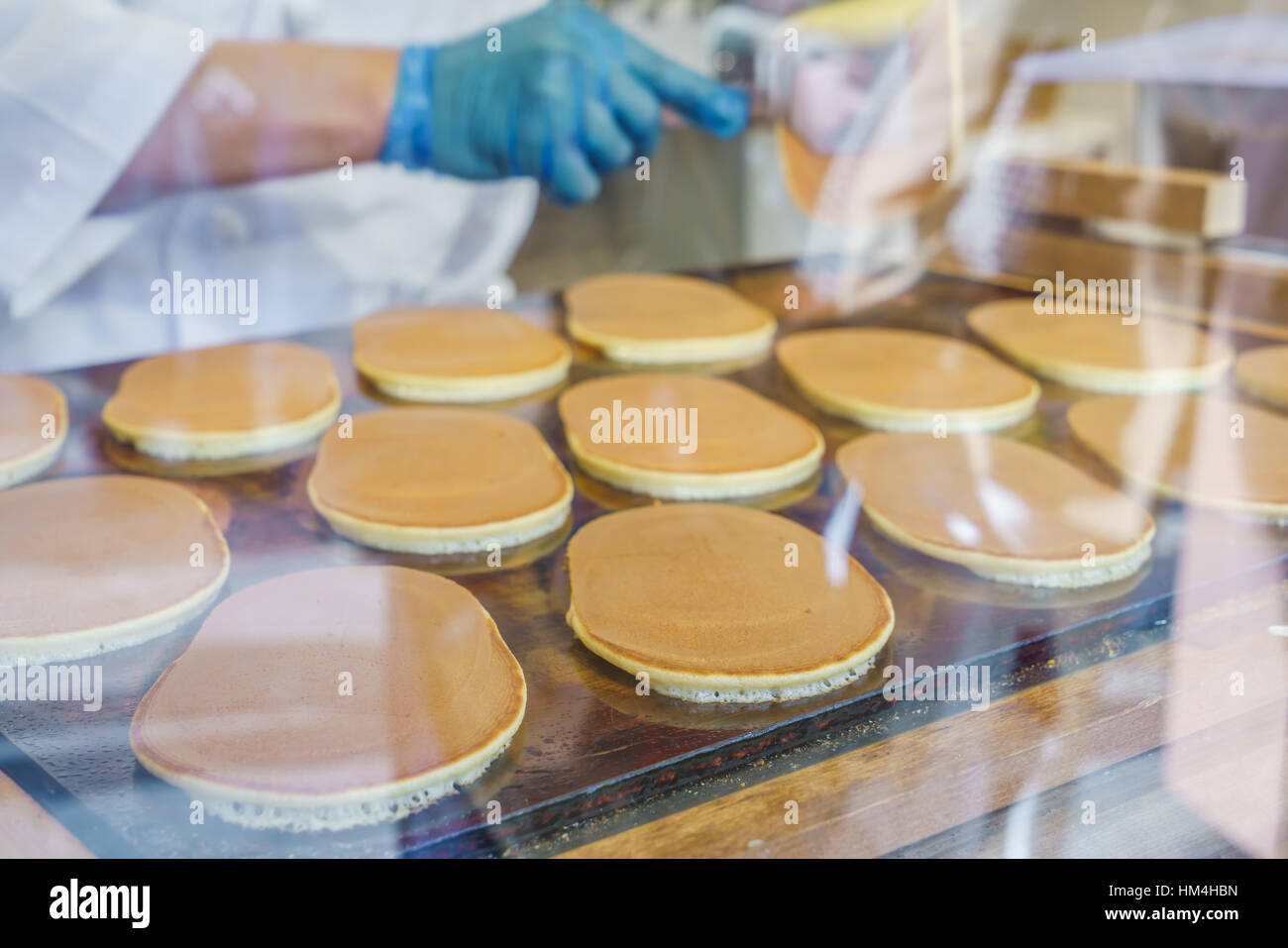 Pancakes cooking ion griddle Stock Photo - Alamy