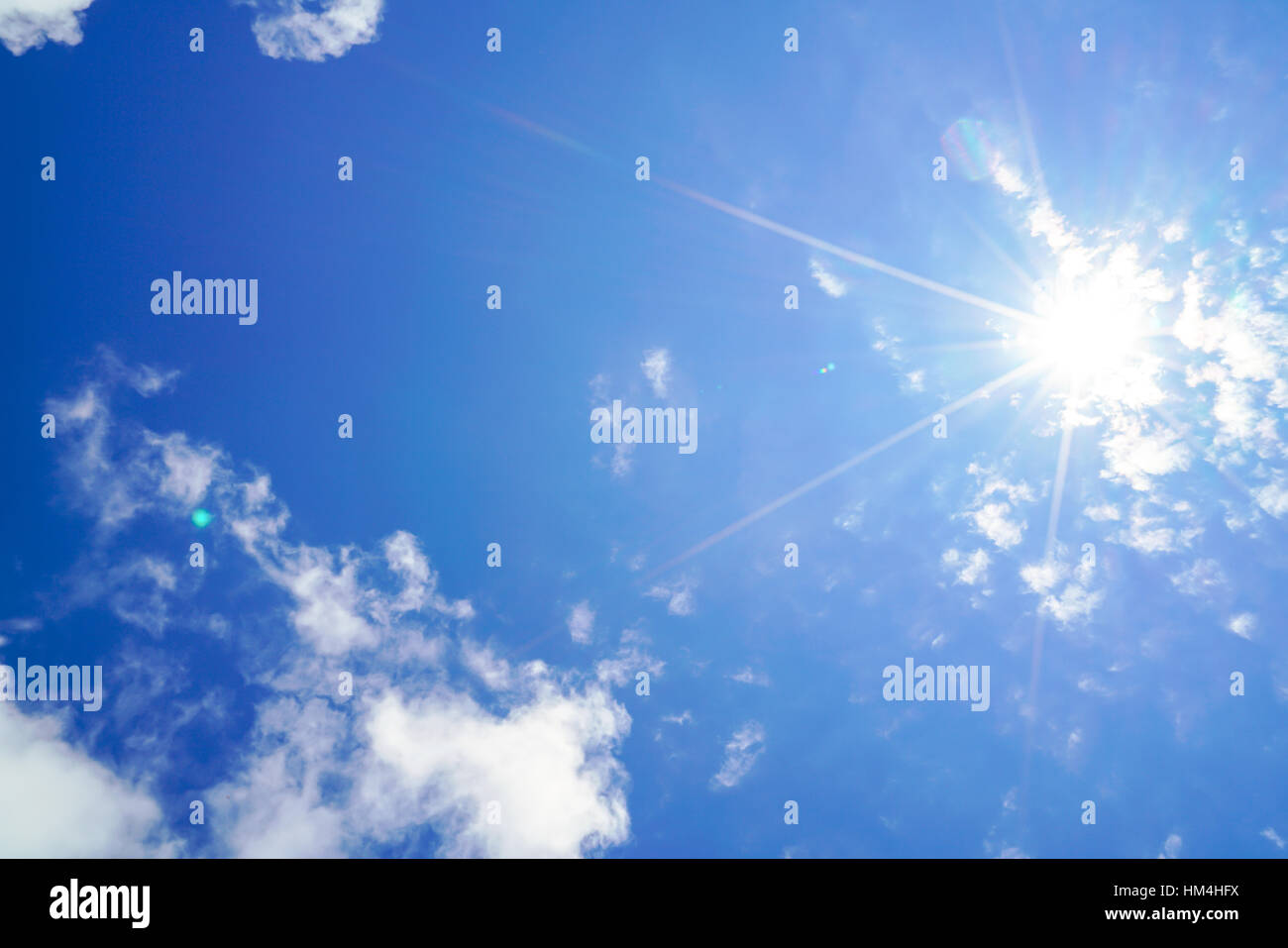Cloud in blue sky with sunrays Stock Photo - Alamy